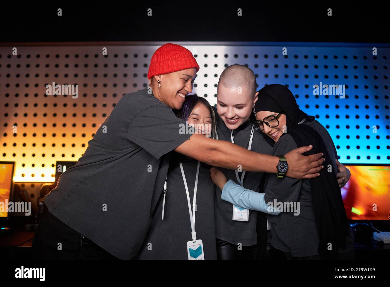 Portrait of diverse female team celebrating victory on stage during ...