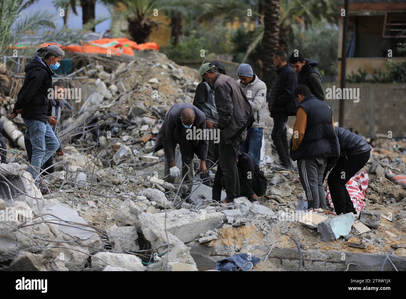 Civil defense team and civilians conduct a search and rescue operation ...