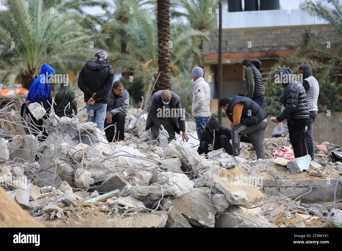 Civil defense team and civilians conduct a search and rescue operation ...