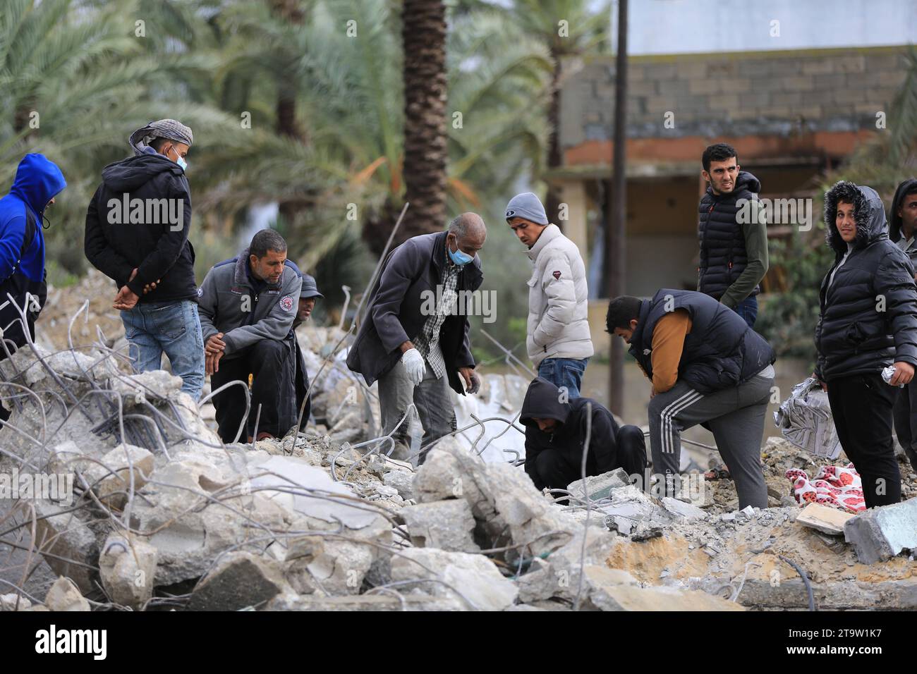 Civil defense team and civilians conduct a search and rescue operation ...