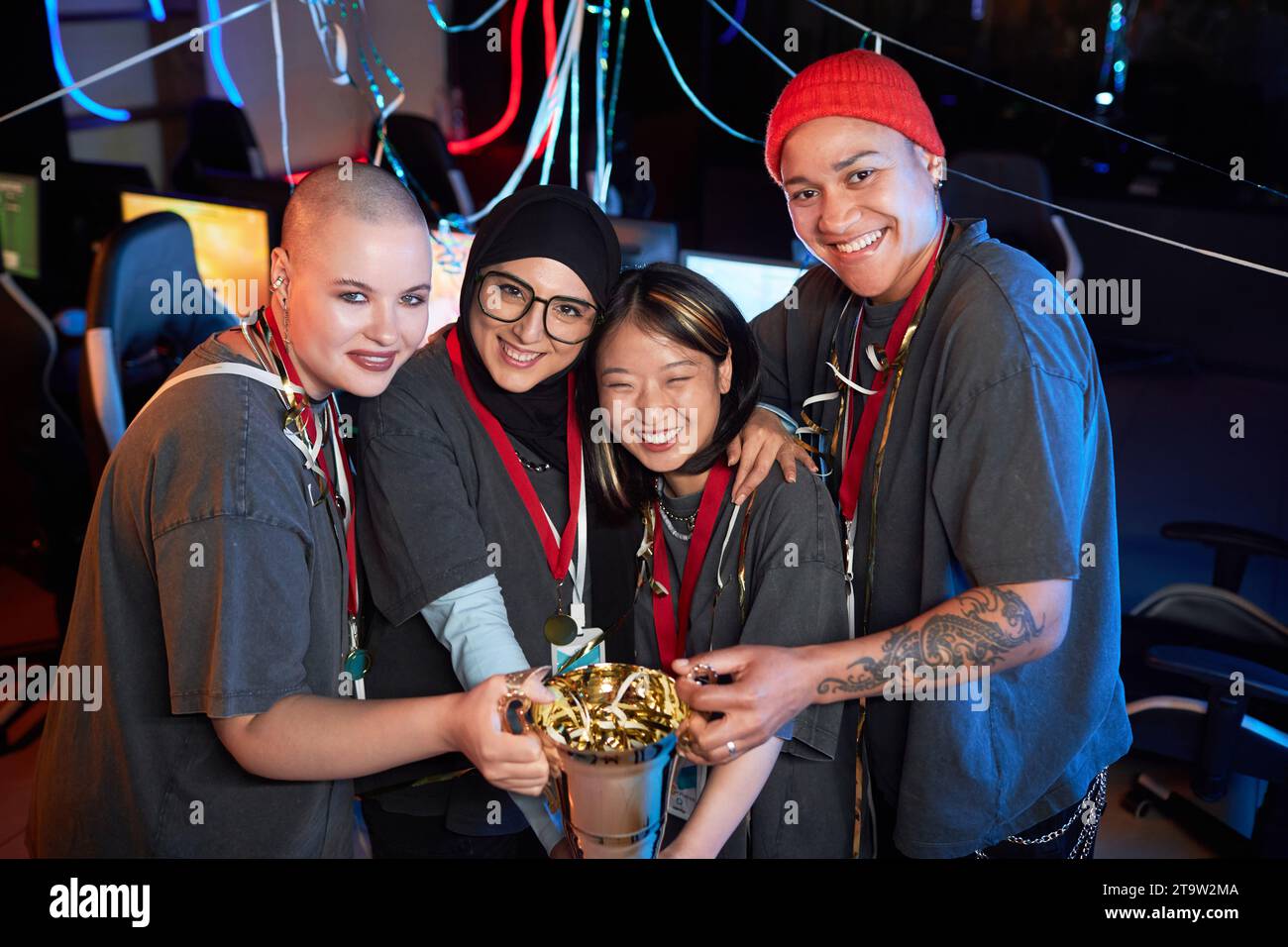 Diverse team of professional female gamers celebrating victory in ...