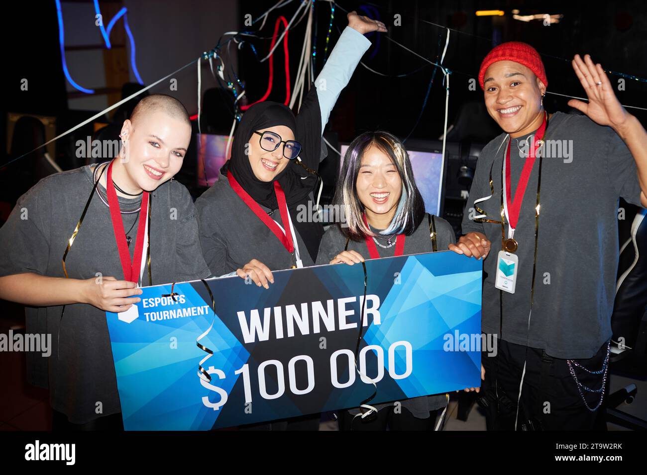 Diverse team of professional female gamers celebrating victory in ...