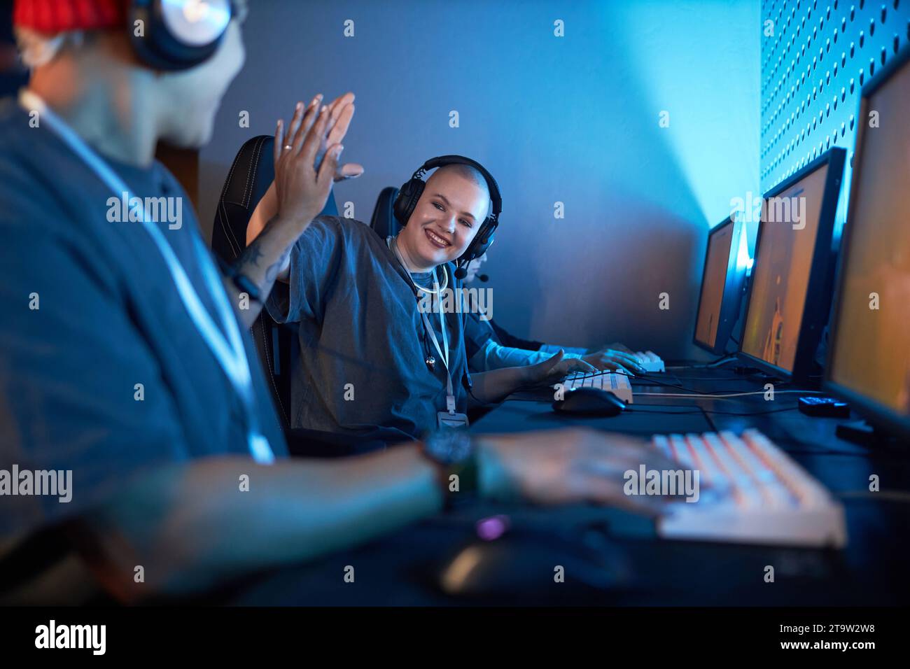Vertical portrait of gen Z young woman playing video games ...