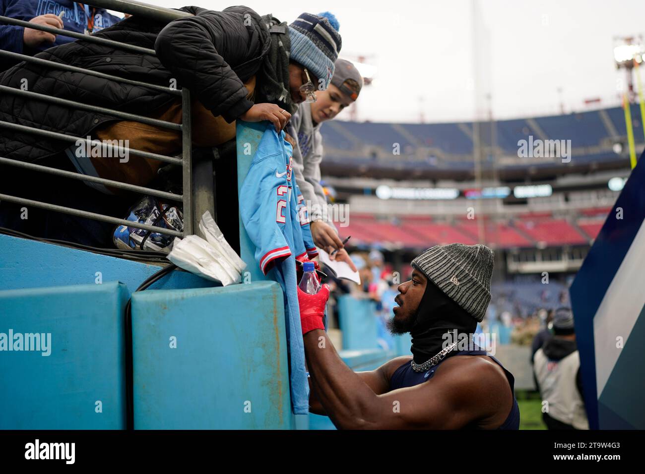 Tennessee Titans linebacker Azeez Al-Shaair, right, signs autographs ...