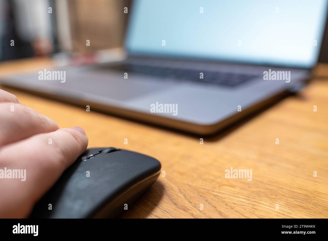 Bavaria, Germany - November 24, 2023: Man operating the mouse of a ...