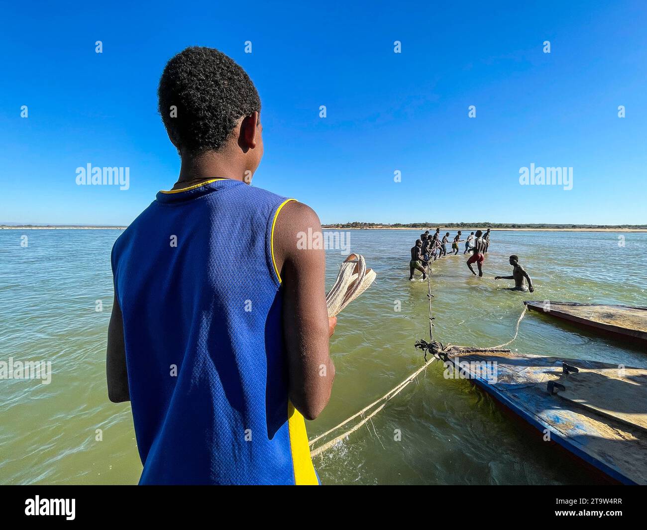Madagascar, Tsiribihina river, young men tow barge on river Stock Photo ...