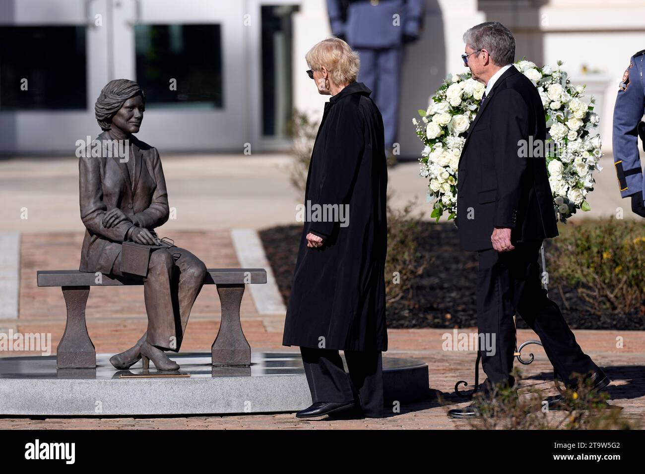 James "Chip" Carter and his wife Becky walks past a statue of former ...