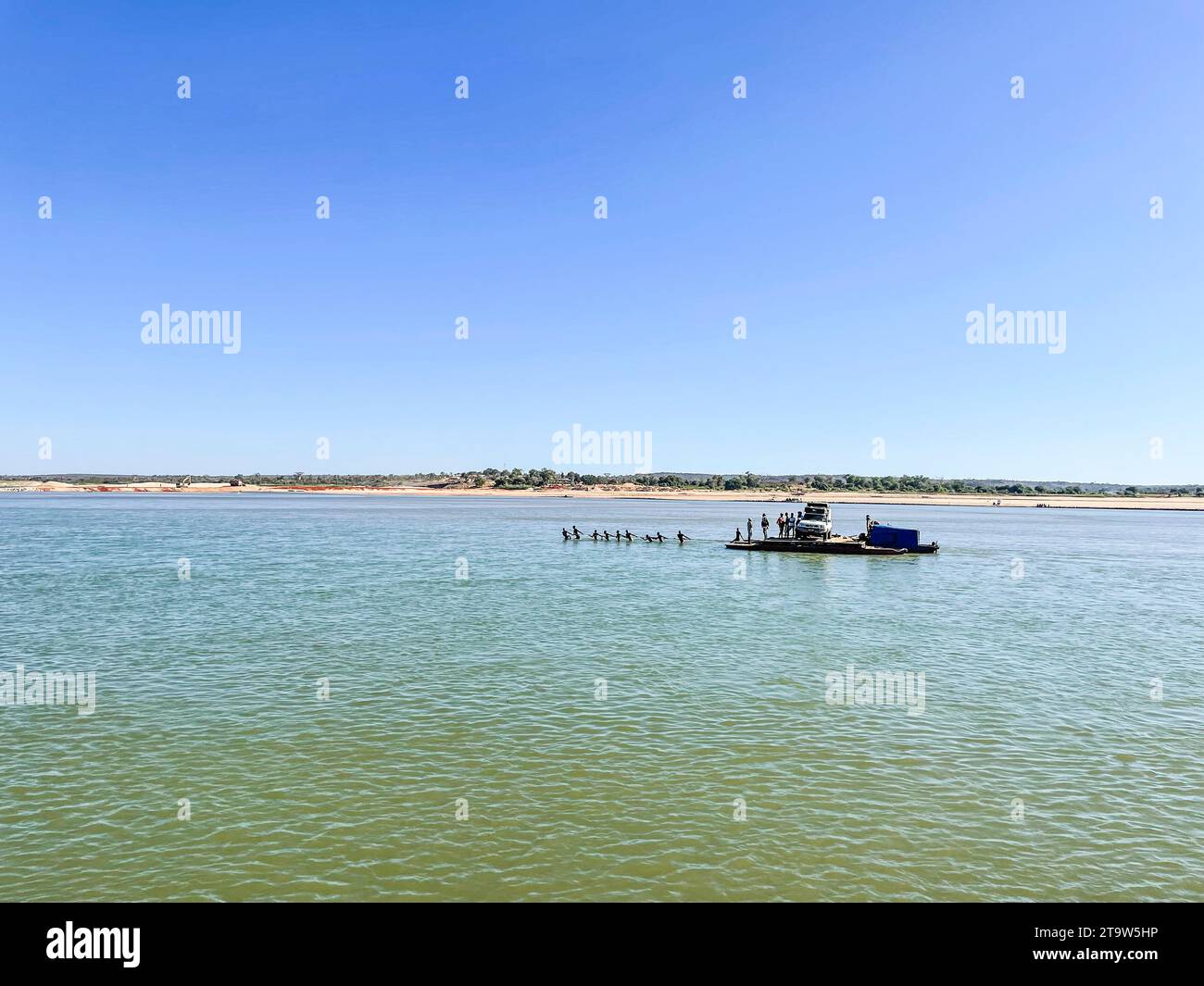 Madagascar, Tsiribihina river, young men tow barge on river Stock Photo ...
