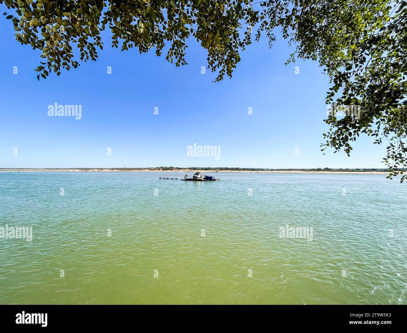 Madagascar, Tsiribihina river, young men tow barge on river Stock Photo ...
