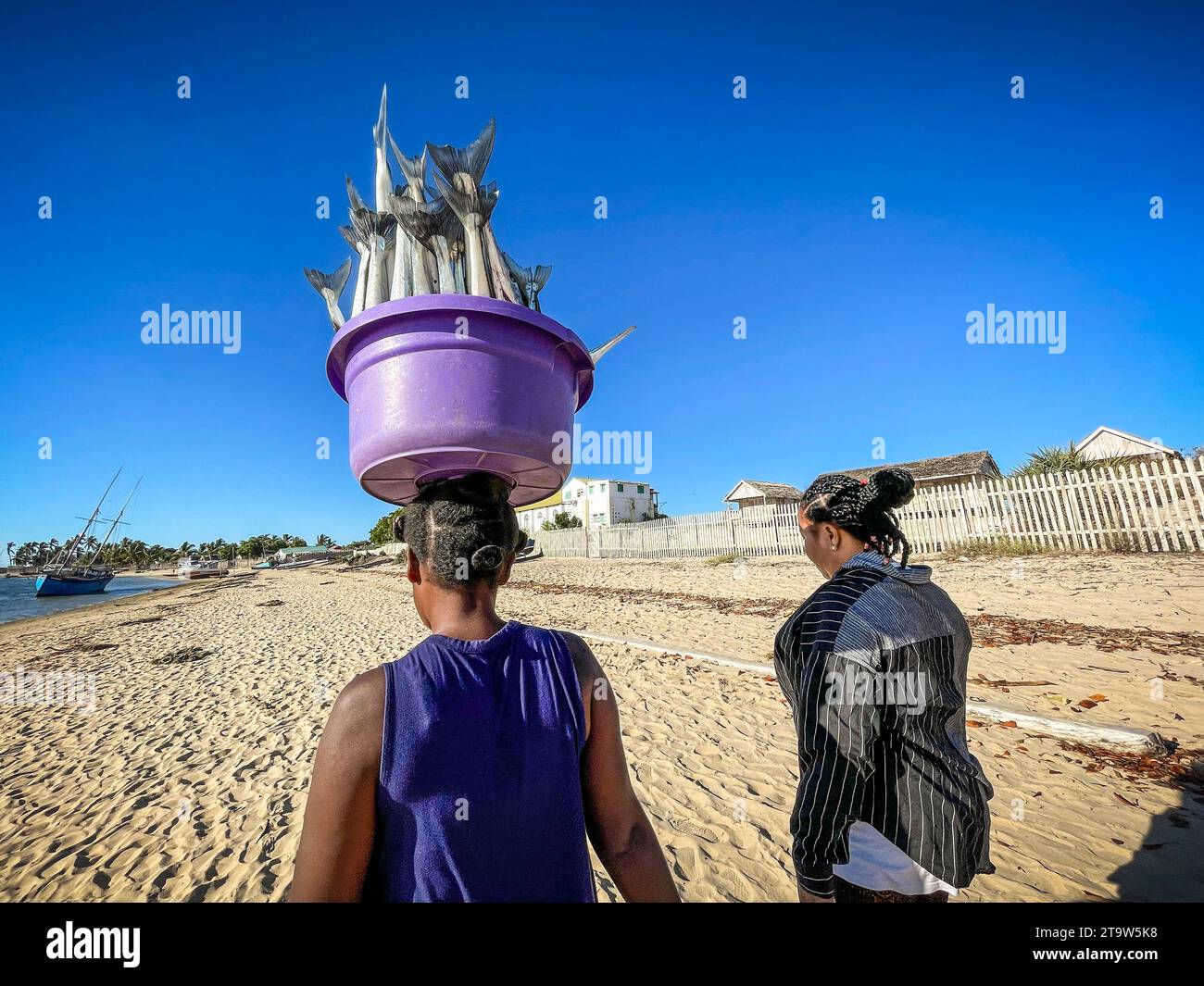 Madagascar, woman carries fish on her head Stock Photo - Alamy