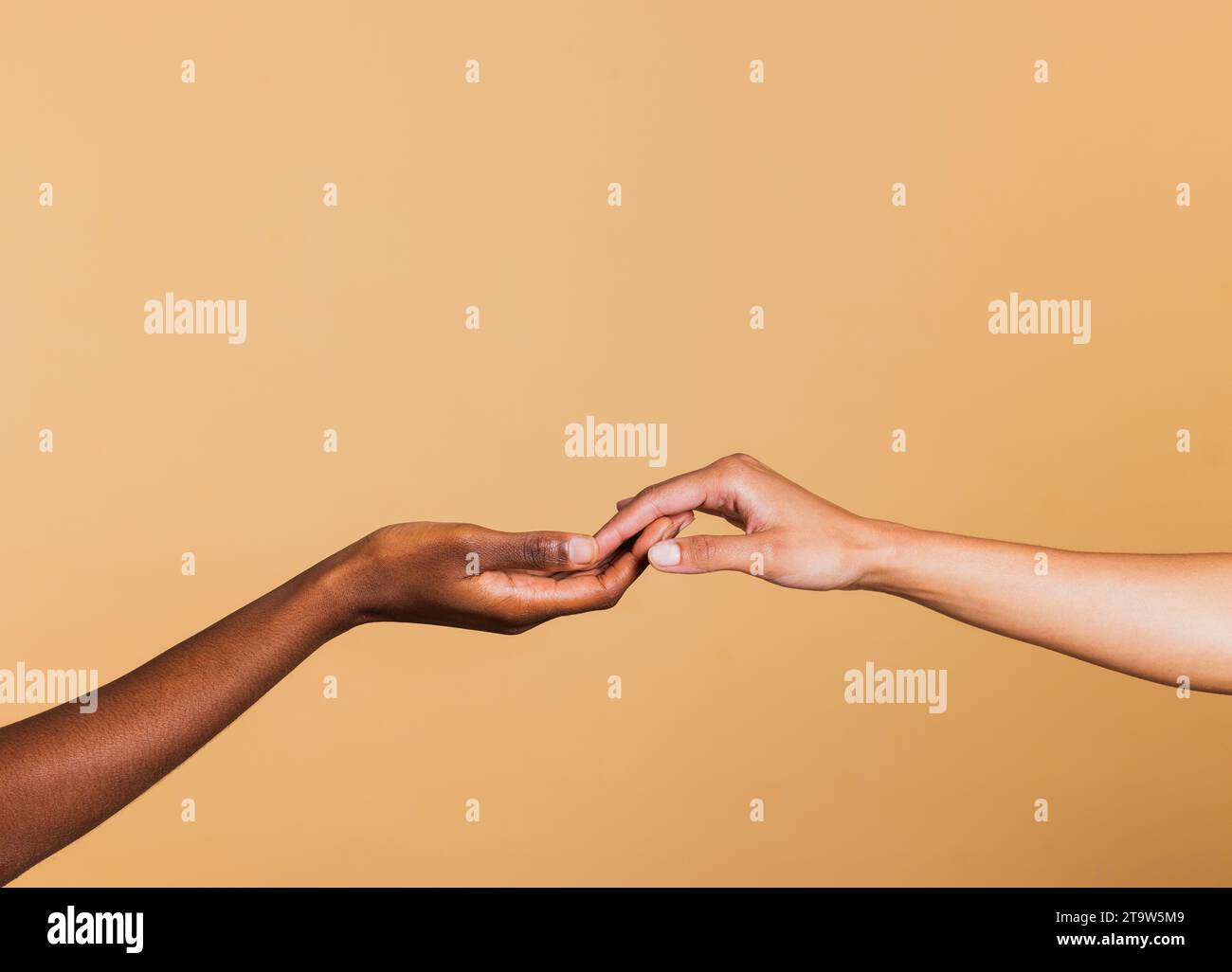 Close up of two female hands together on brown background. Hands of two ...