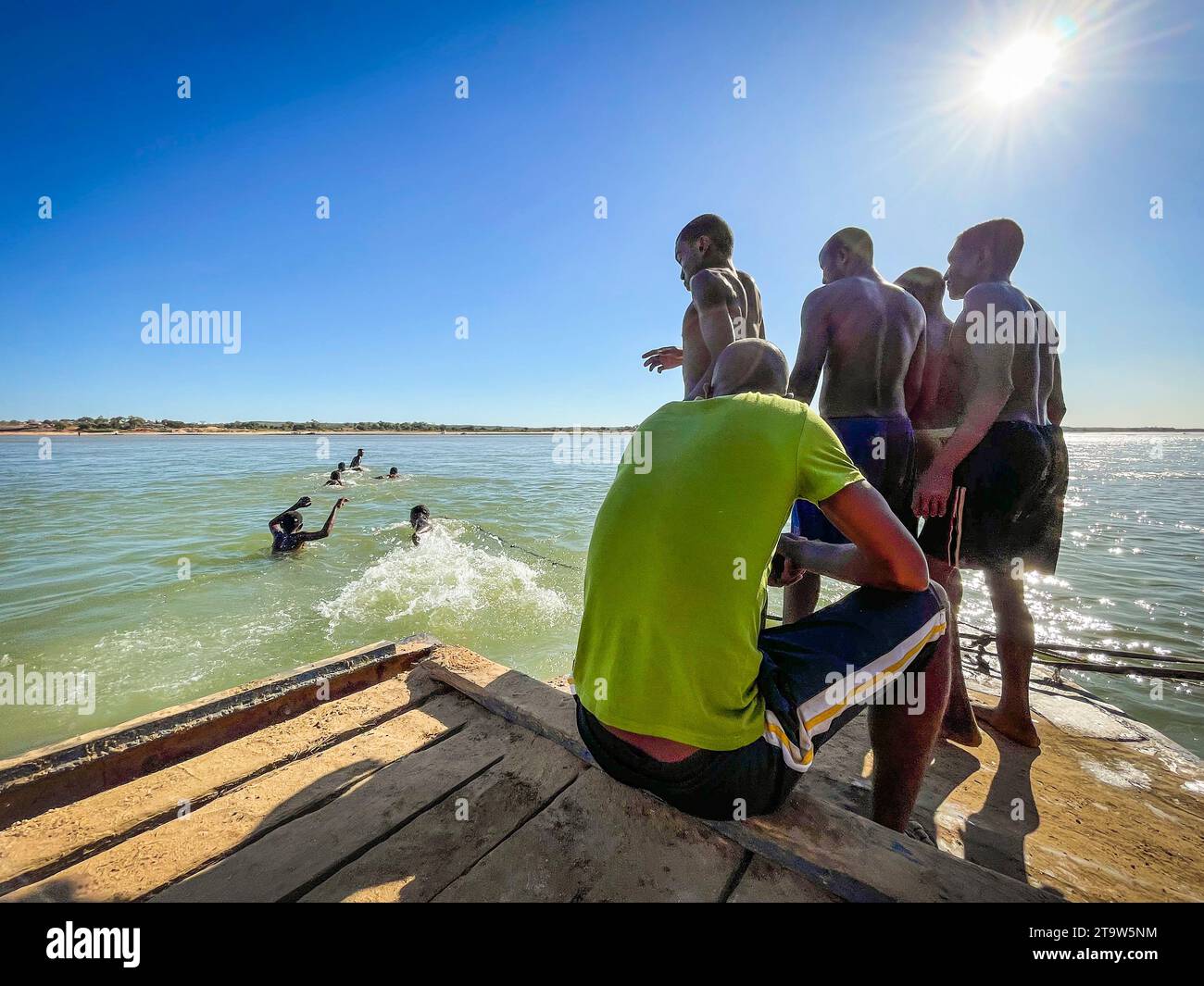 Madagascar, Tsiribihina river, young men tow barge on river Stock Photo ...