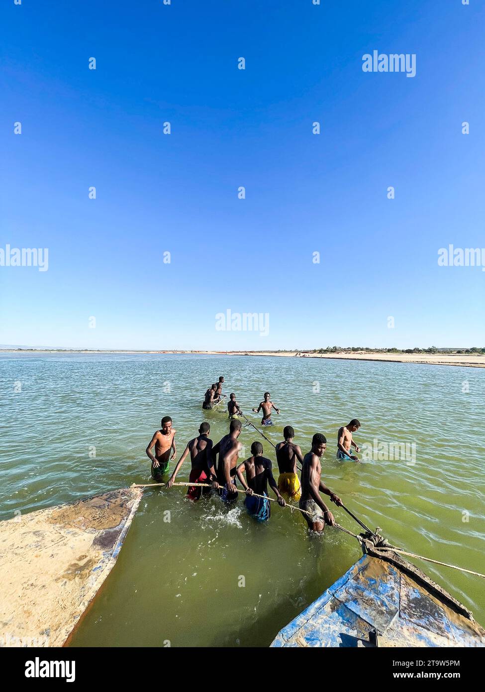 Madagascar, Tsiribihina river, young men tow barge on river Stock Photo ...