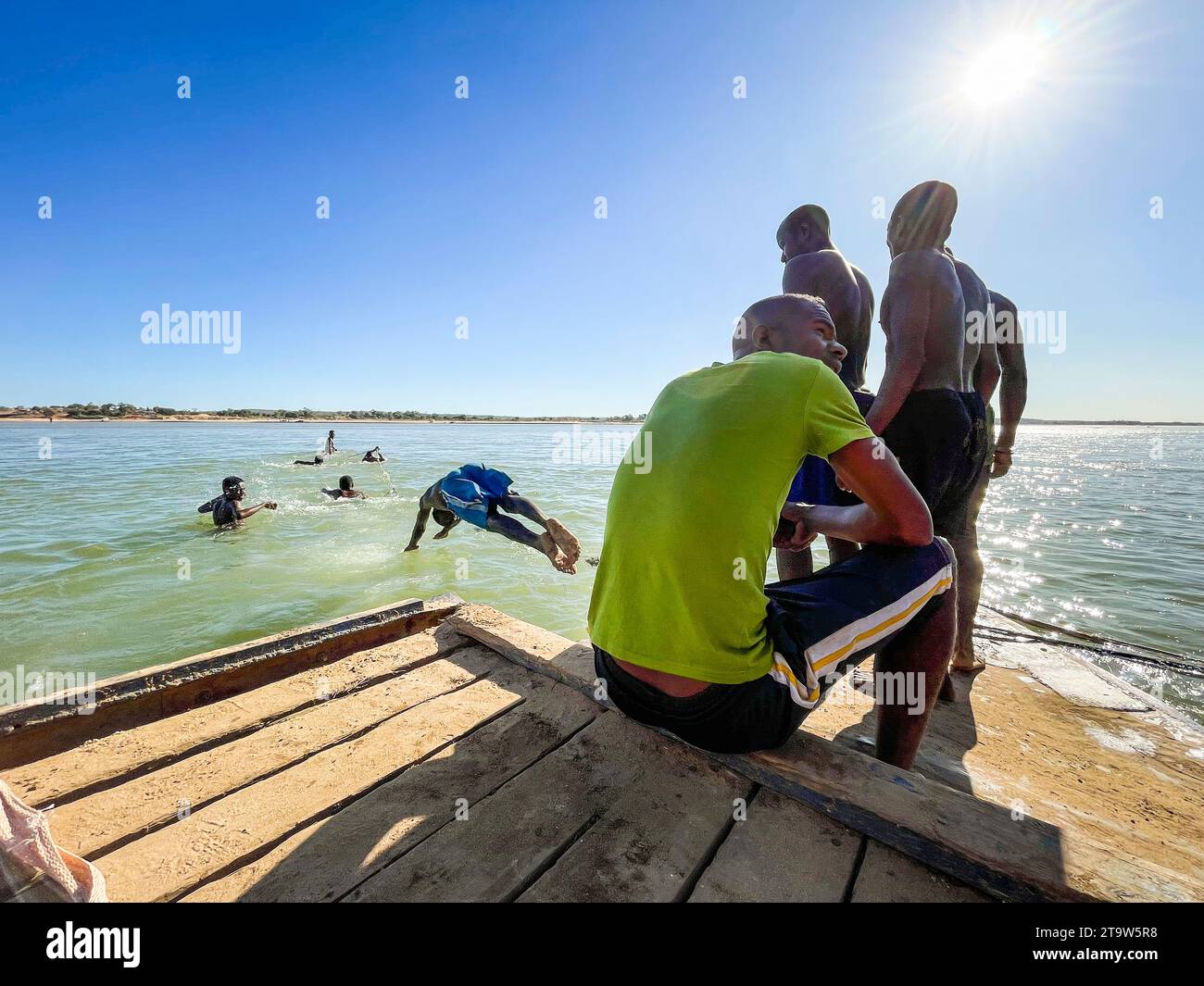 Madagascar, Tsiribihina river, young men tow barge on river Stock Photo ...