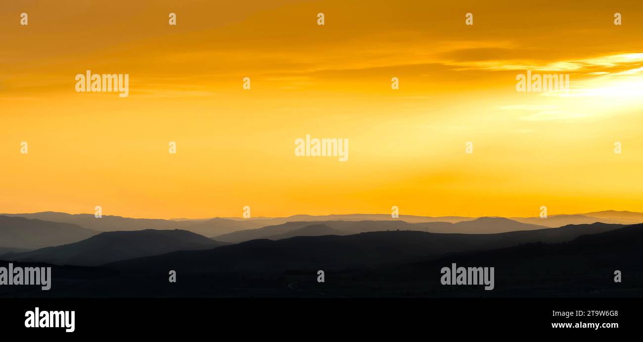 mountains silhouette at sunset, natural light tint warm Stock Photo - Alamy