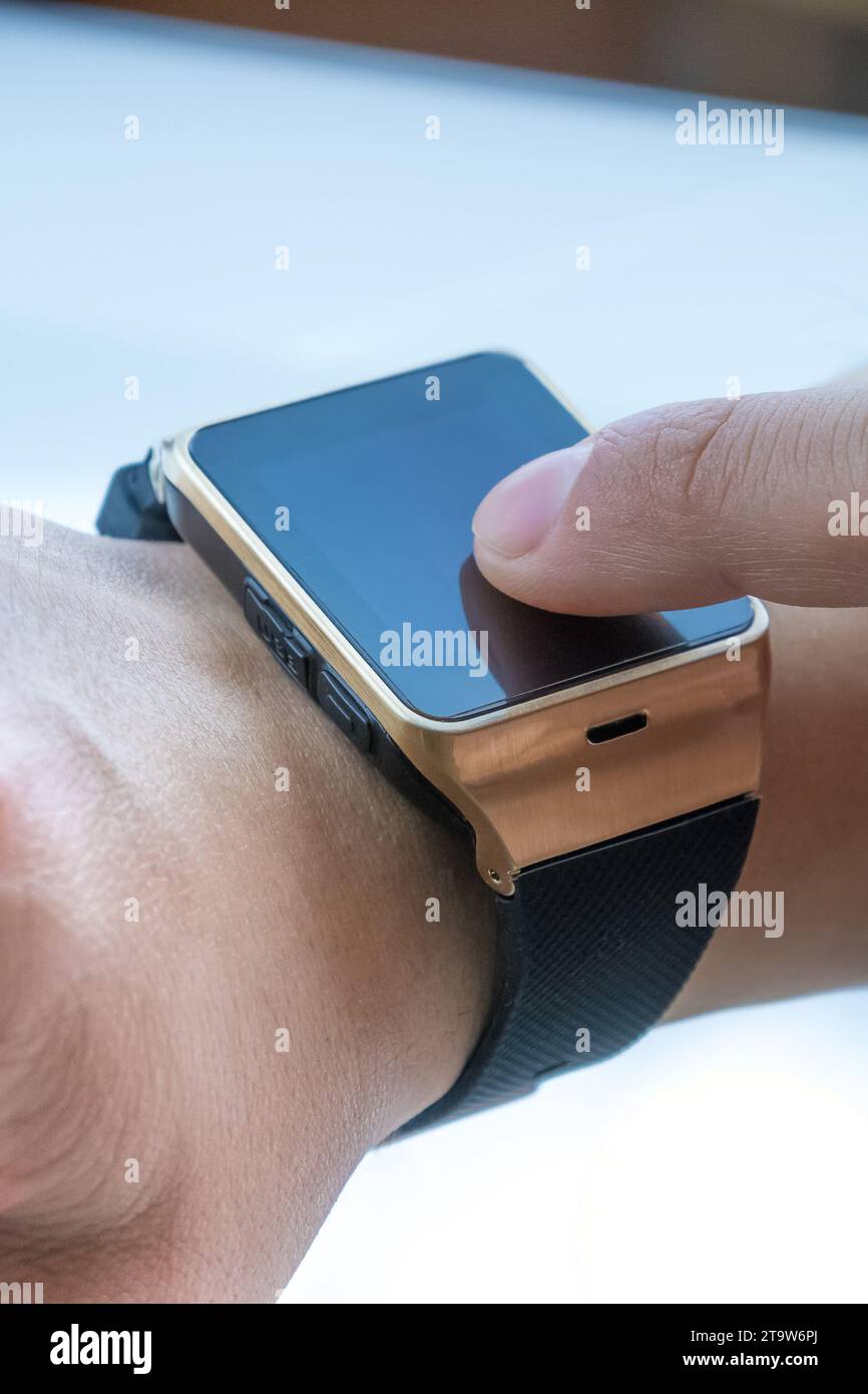 close-up of man using smartwatch app with finger, new technology ...