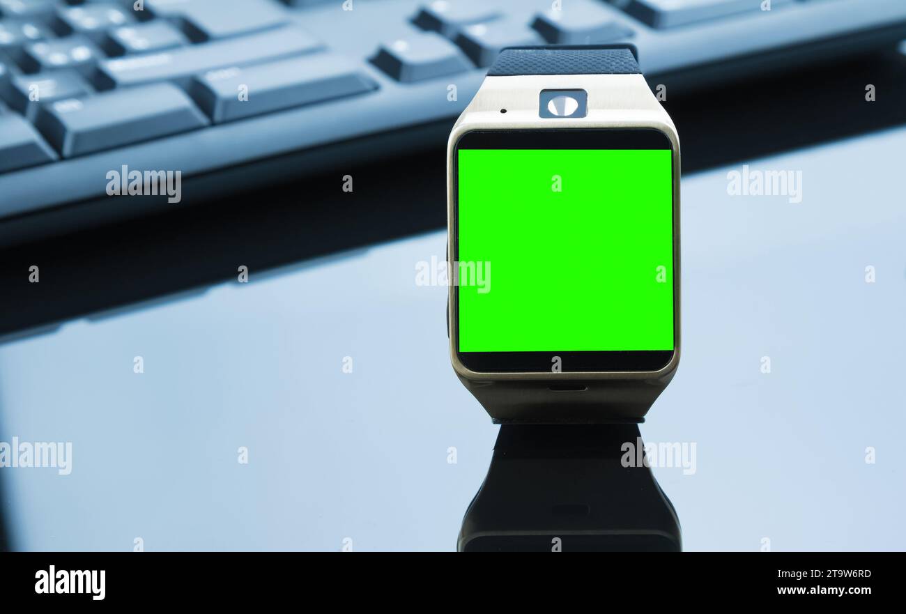 smartwatch near computer pc keyboard and mouse with chroma key green ...