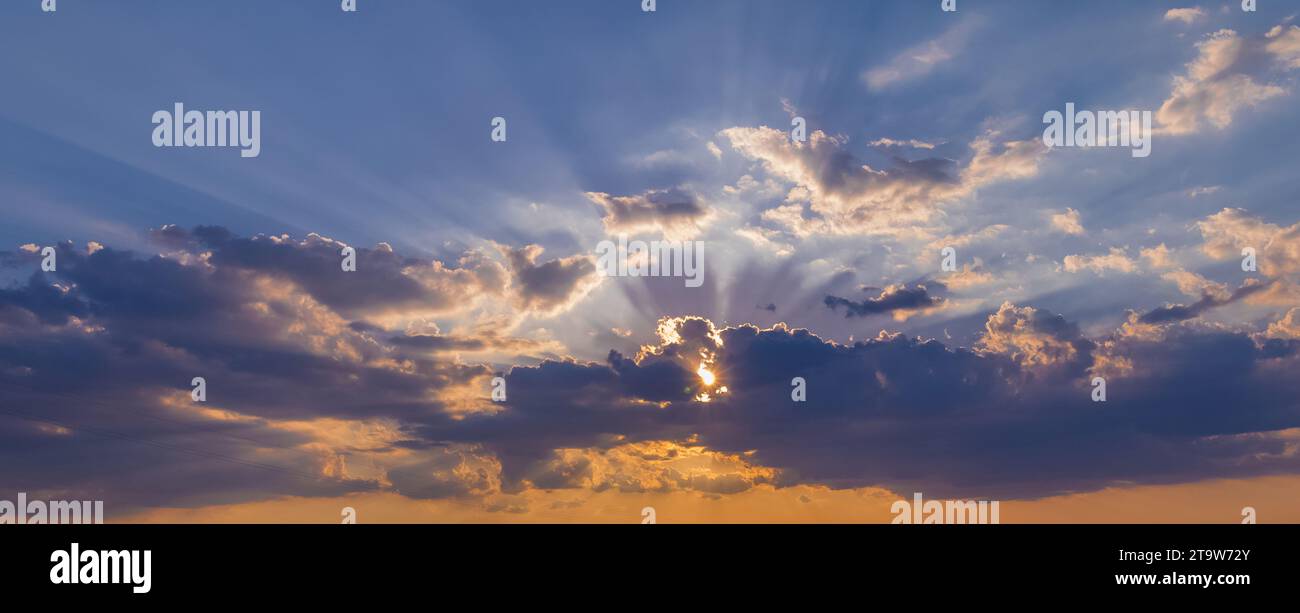 sunset scene with sun fall and ray light, clouds in background, warm ...