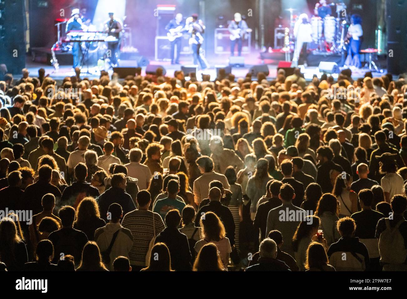 Happy people enjoying performance of popular band Stock Photo - Alamy
