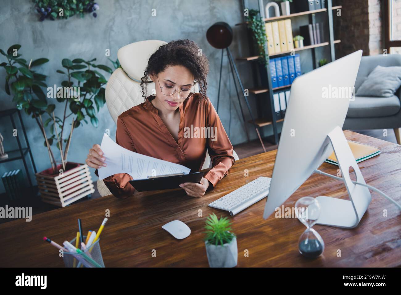 Portrait of clever company accountant lady sitting chair read clipboard ...