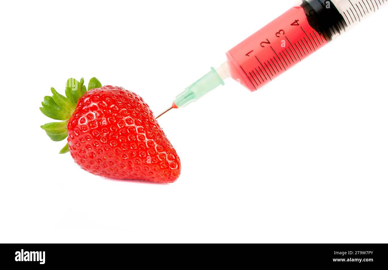 medical injection with liquid and a red strawberry, nutrition and ...