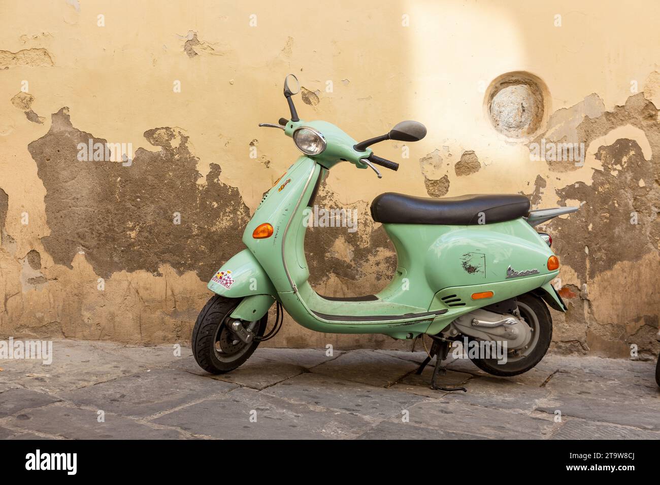 Green Vespa scooter on a street in the village of Cortona, Italy Stock ...
