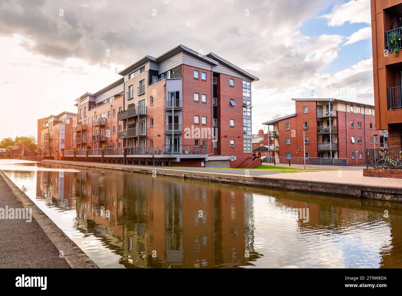 Modern apartment buildings in a housing development along a canal under ...