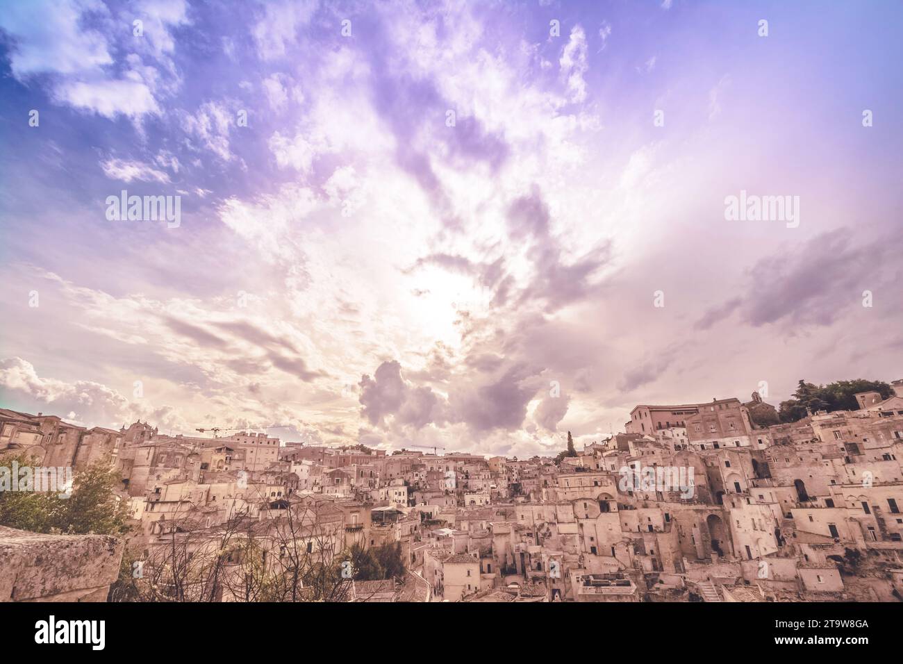 typical view of stones (Sassi di Matera) of Matera under sunset sky ...