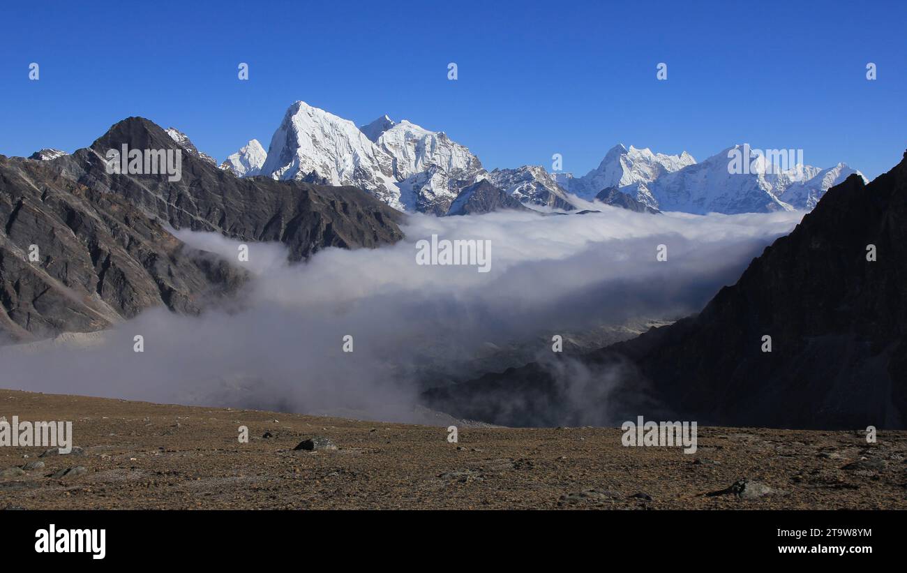 Sea of fog in the Gokyo Valley and snow capped high mountains of the ...