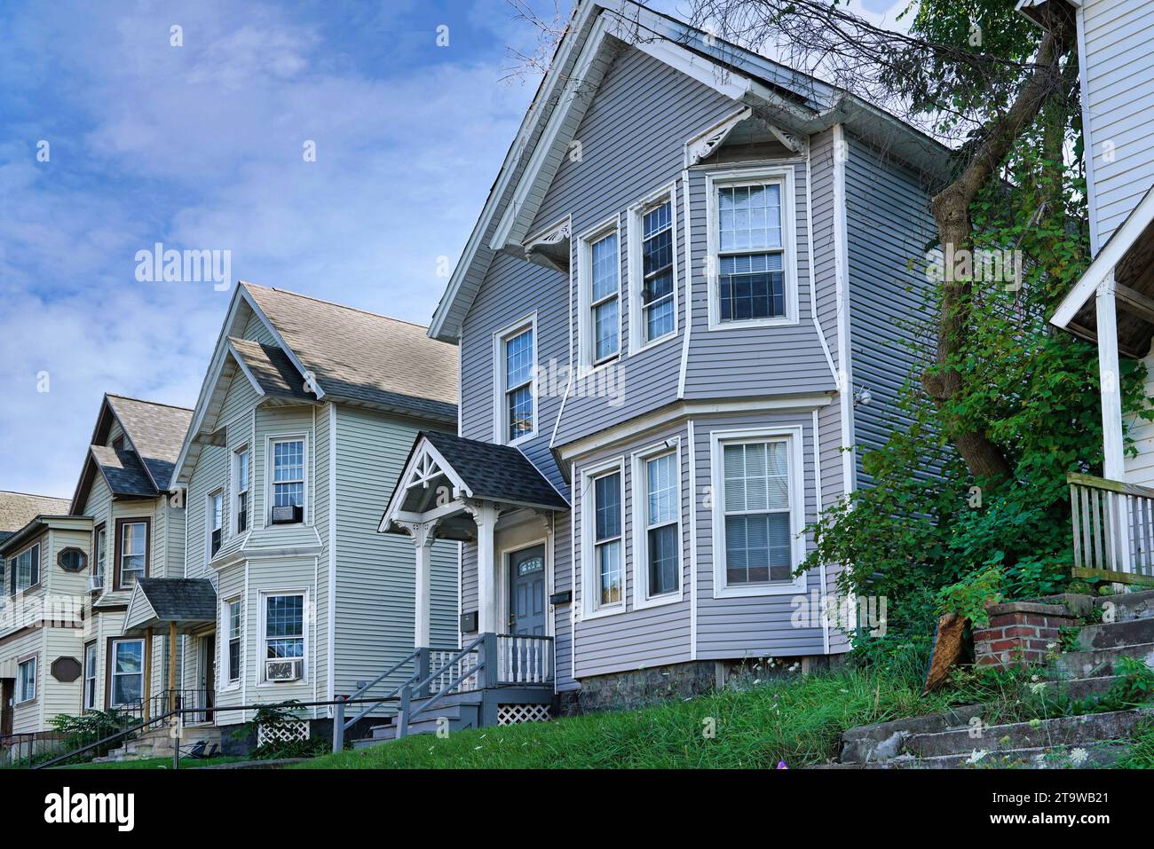 Row of two story clapboard houses with gables Stock Photo - Alamy