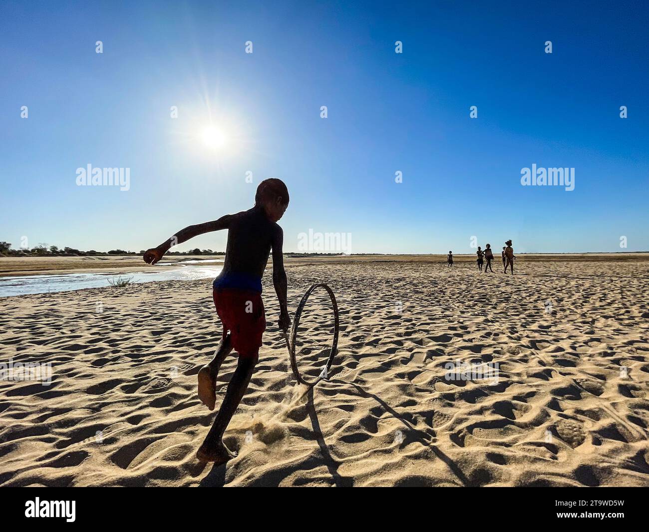 Madagascar, child plays on the sandy banks of the Tsiribihina river ...