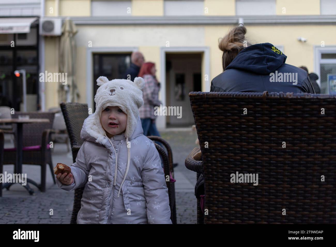 Belgrade, Serbia, Nov 19, 2023: A baby girl holding French pastry ...