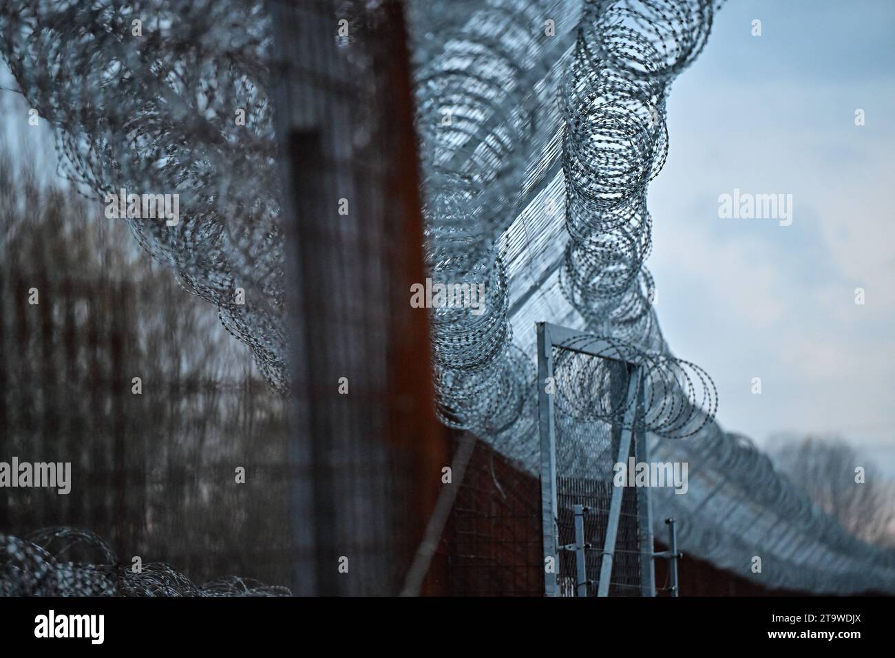 Roszke, Hungary. 27th Nov, 2023. A barbed wire fence stands on the ...
