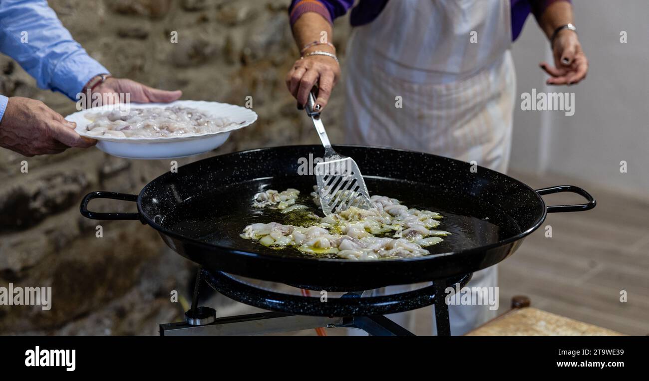 Detail of how to cook calamari in a big pot to make a family meal Stock ...
