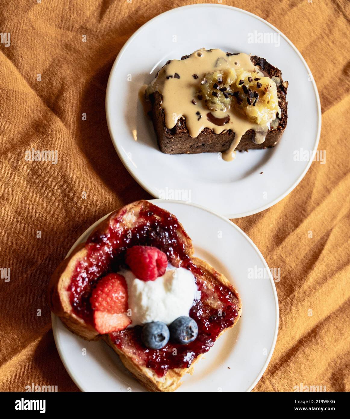 Variety of two desserts a banana bread and a brioche toast with berries ...