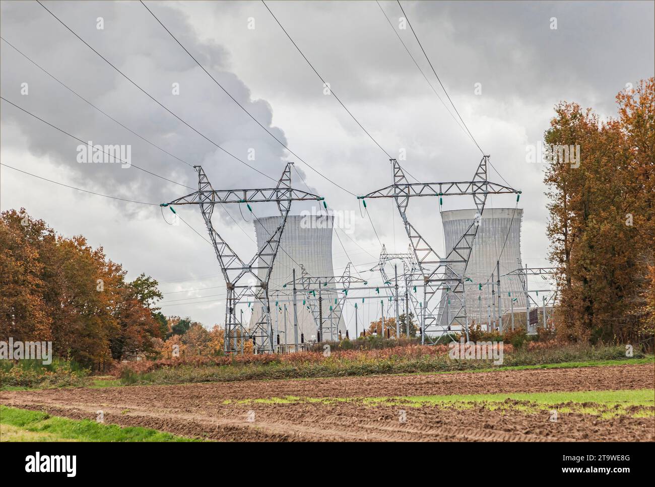 The towers and pylons of a nuclear power station across fields Stock ...