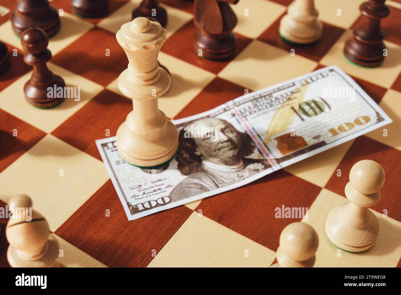 Money in US dollars with chess pieces of kings on the chessboard, close ...