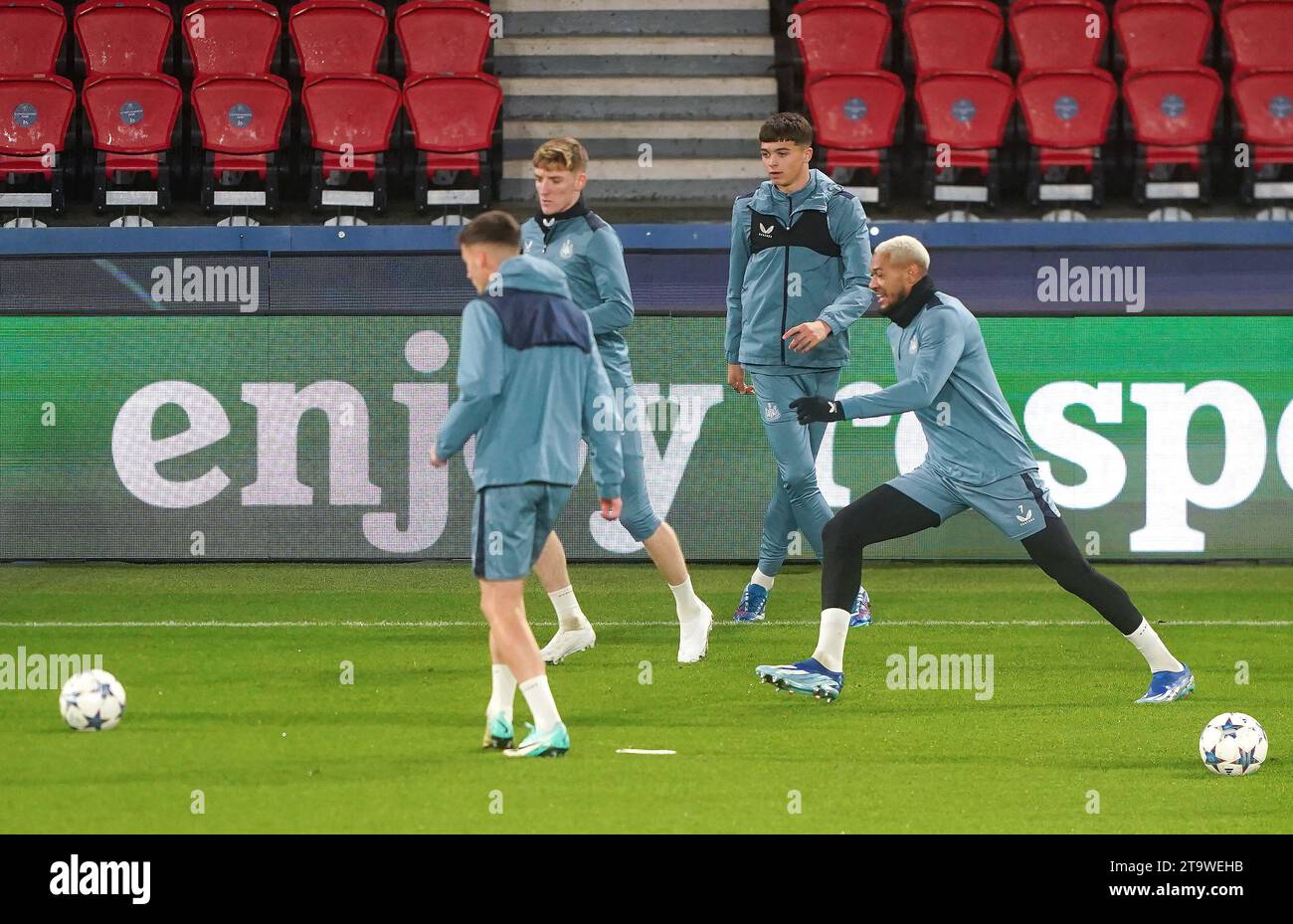 Newcastle United's Joelinton (right) watched by Lewis Miley (second ...