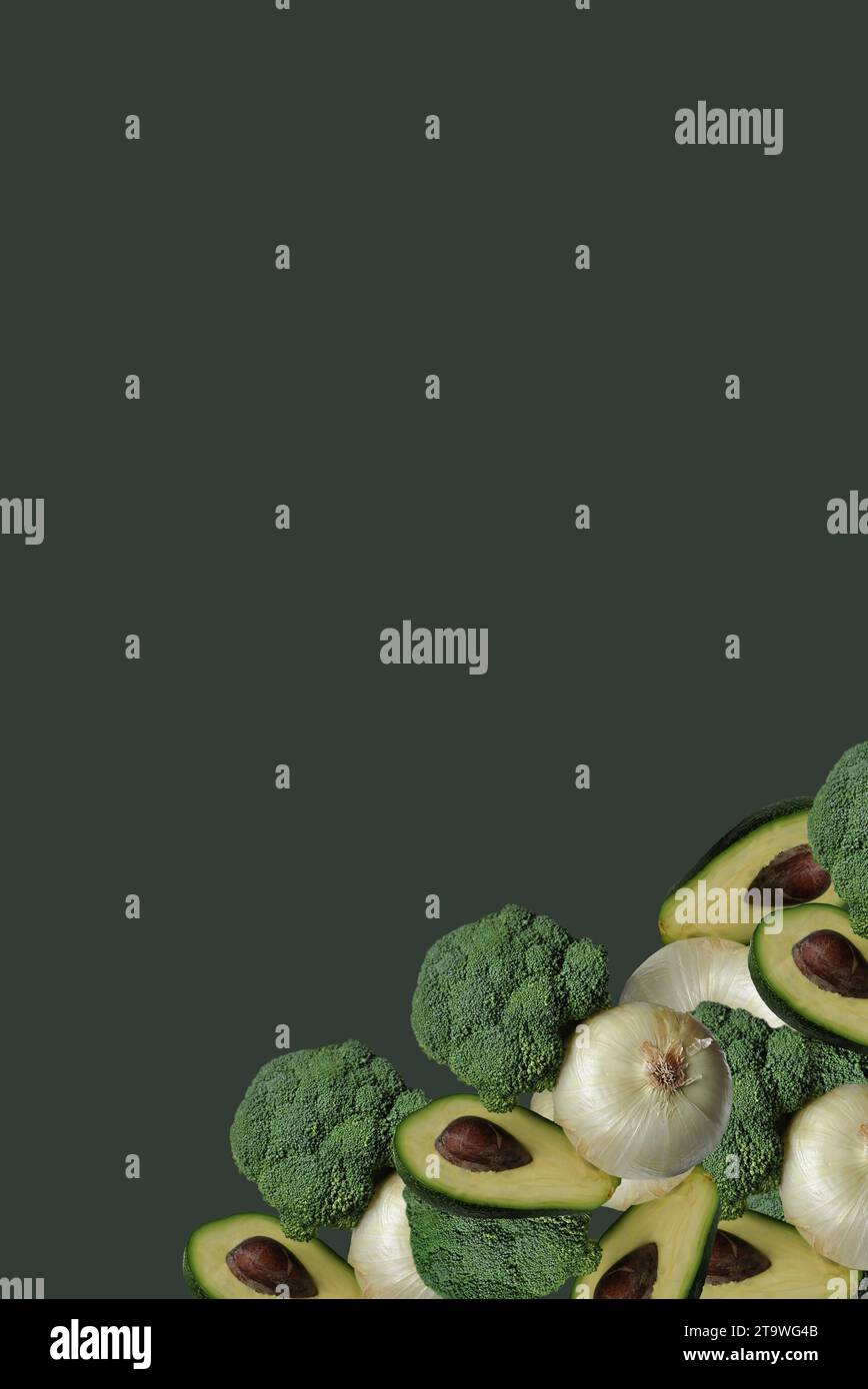 Composition with cut out broccoli, light onions, avocado halves ...