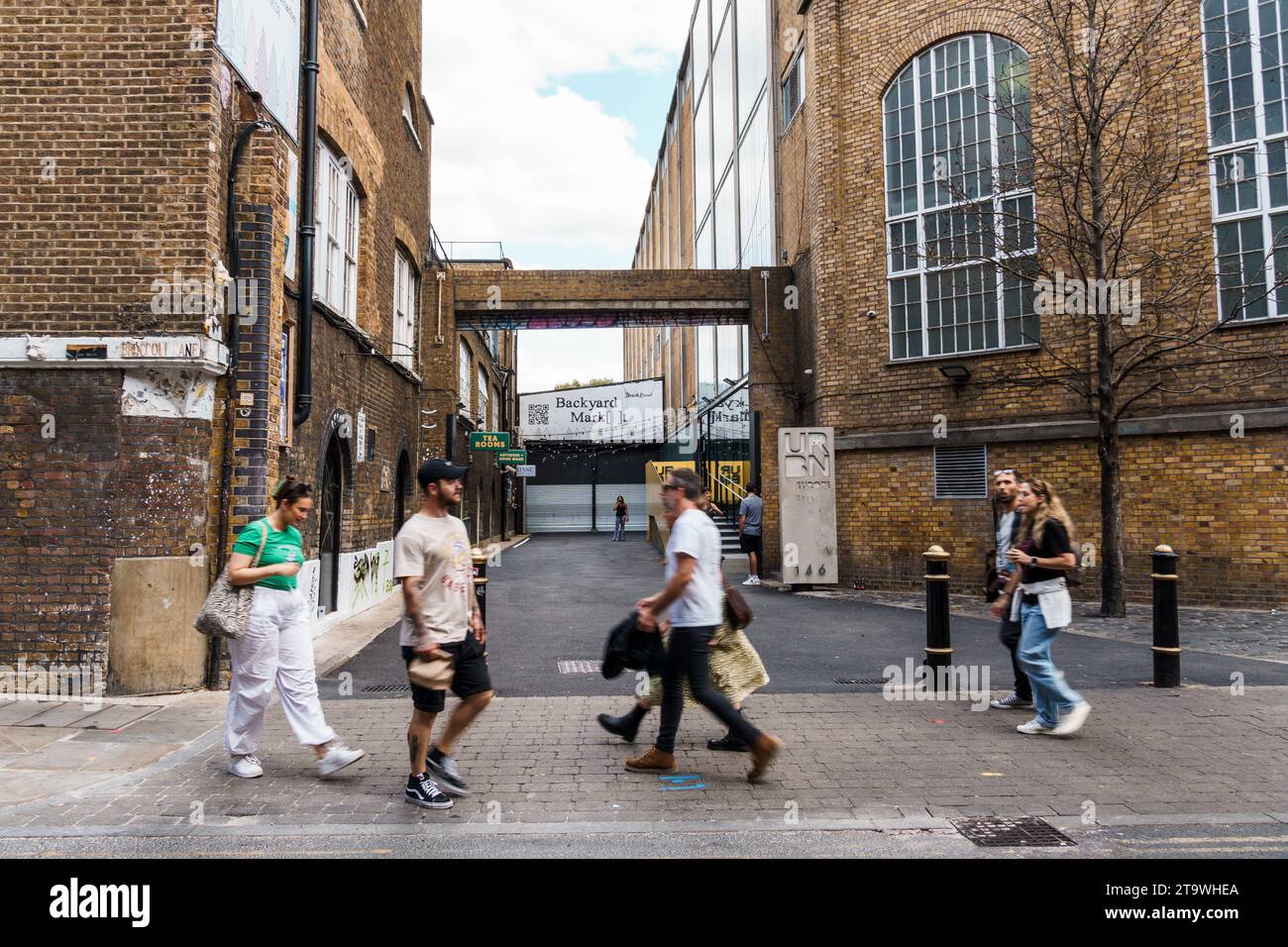 London, UK - August 25, 2023: Street scene with people walking by Brick ...
