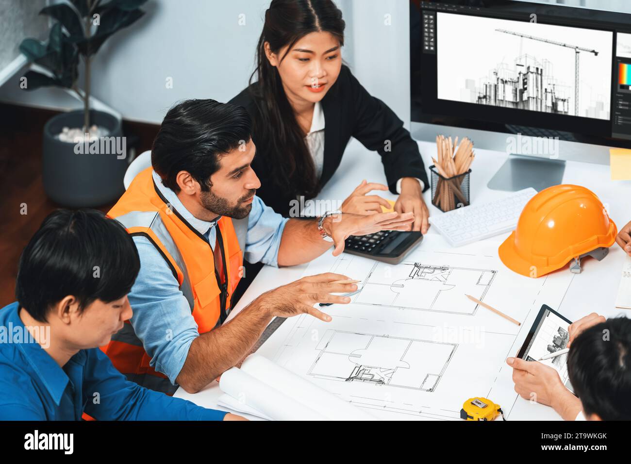 Diverse group of civil engineer and client working together on ...