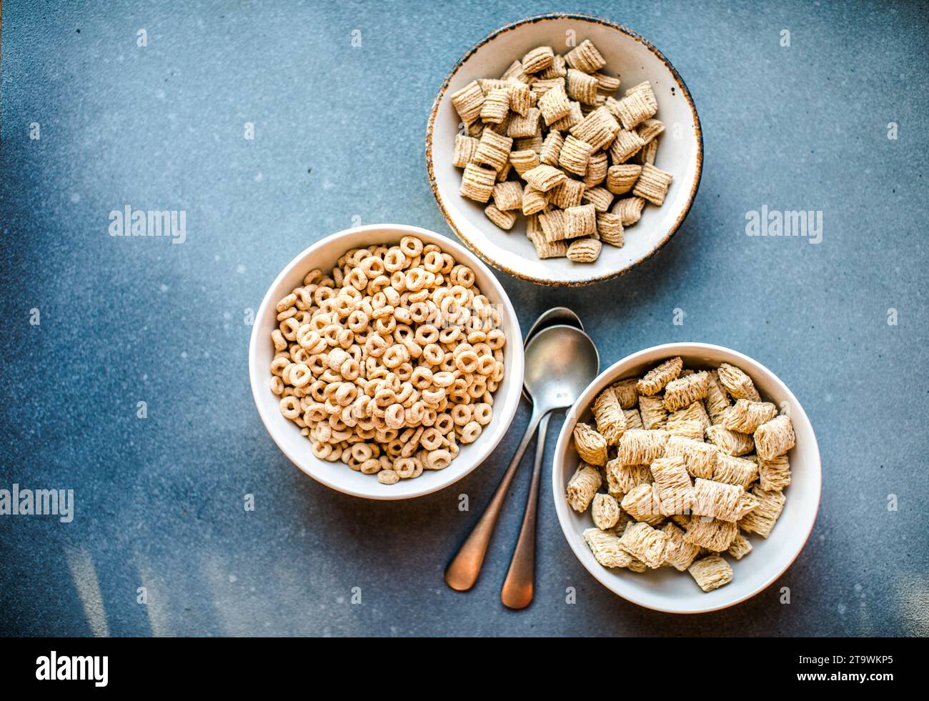 Set of various tasty breakfast cereals on light grey table, flat lay ...