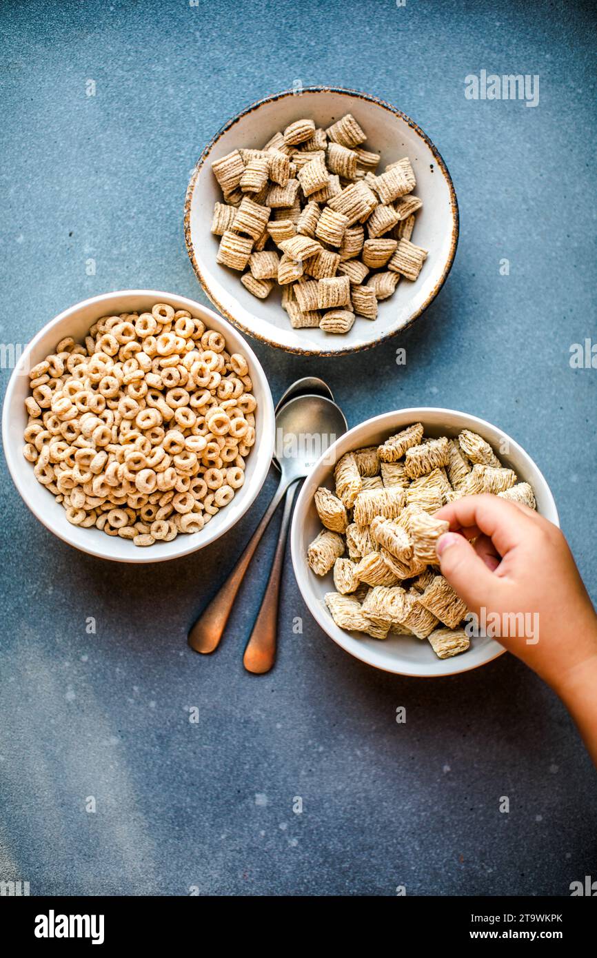Set of various tasty breakfast cereals on light grey table, flat lay ...