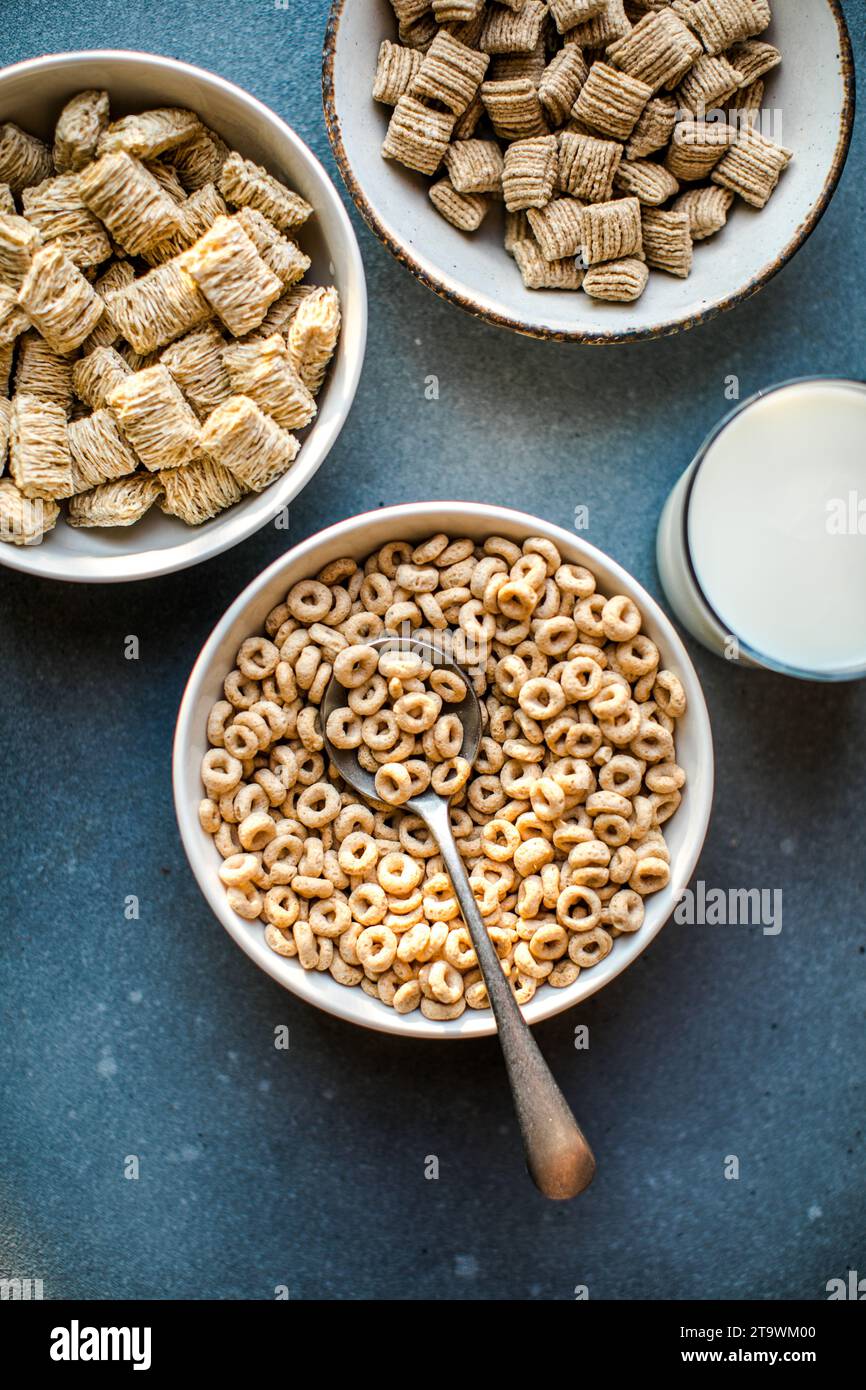 Set of various tasty breakfast cereals on light grey table, flat lay ...