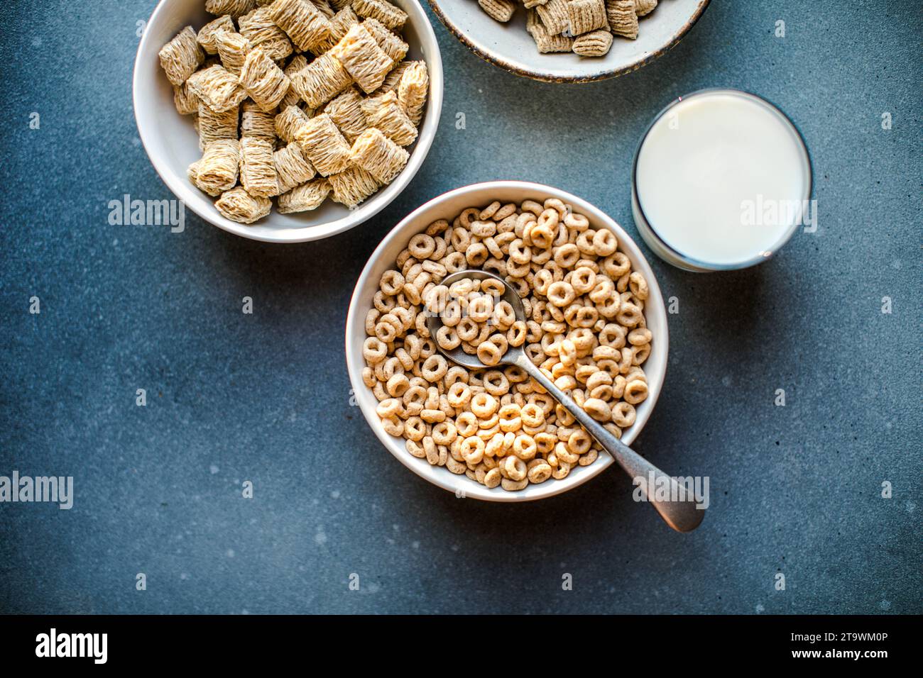 Set of various tasty breakfast cereals on light grey table, flat lay ...
