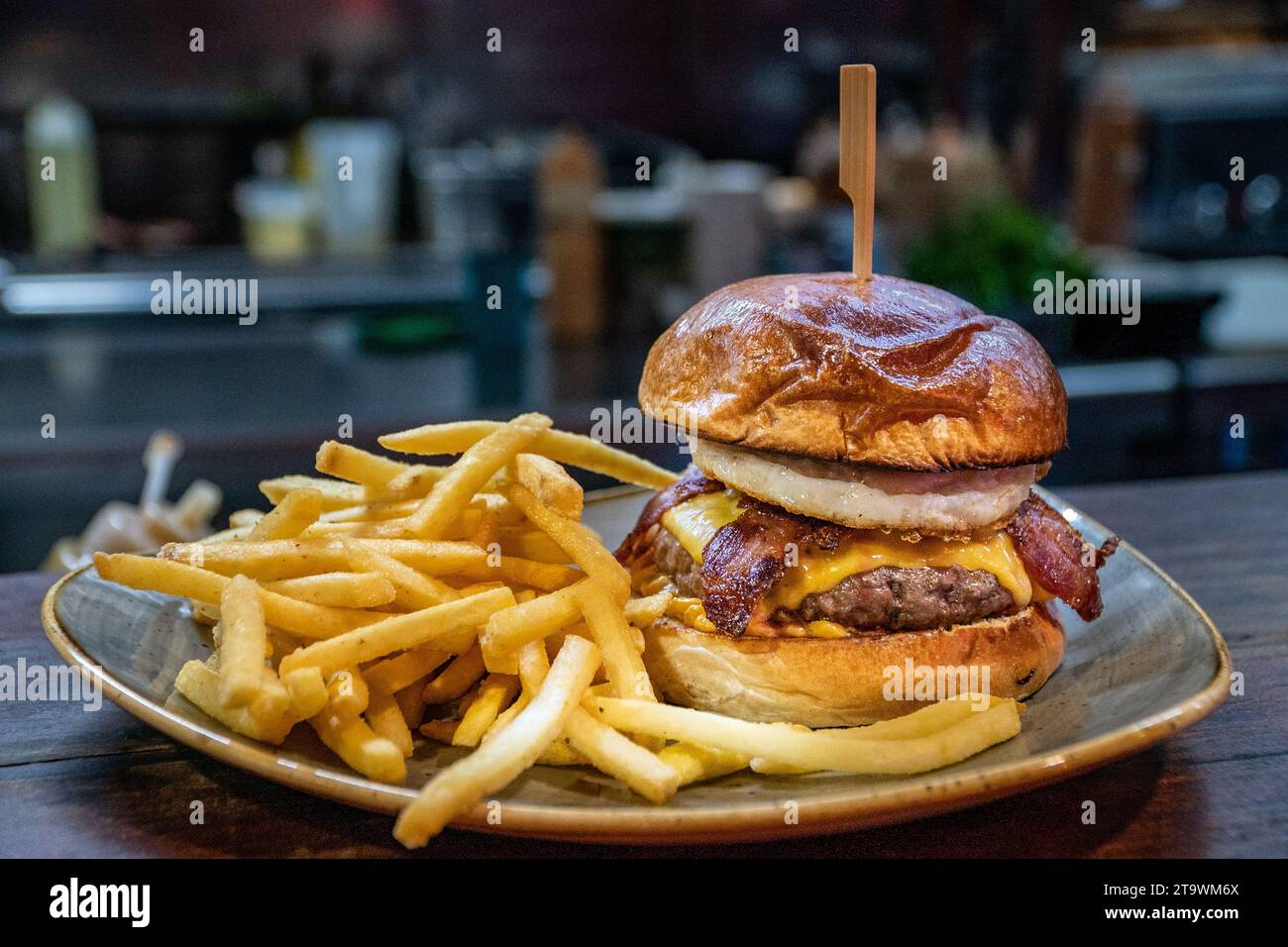 a freshly grilled angus beef cheeseburger with bacon and egg served ...