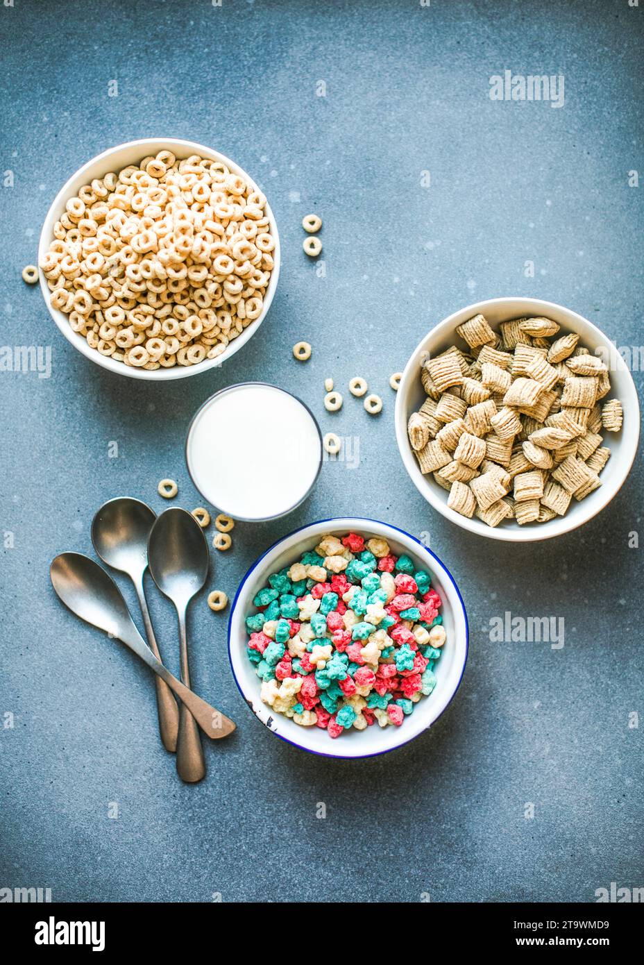 Variety of breakfast whole grain cereals and muesli in bowls on a light ...