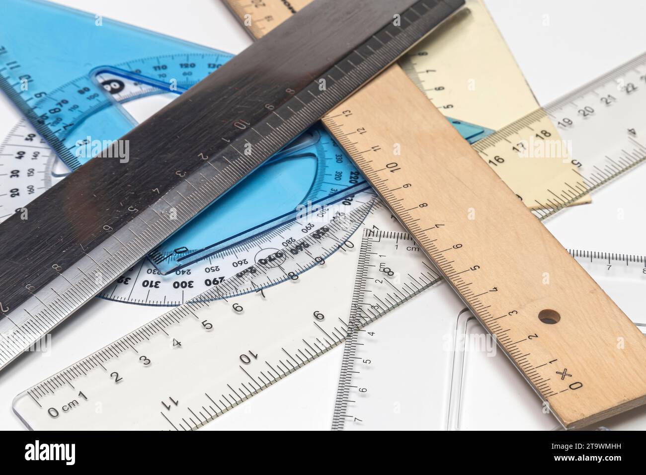 Various rulers of different shapes on white background Stock Photo - Alamy