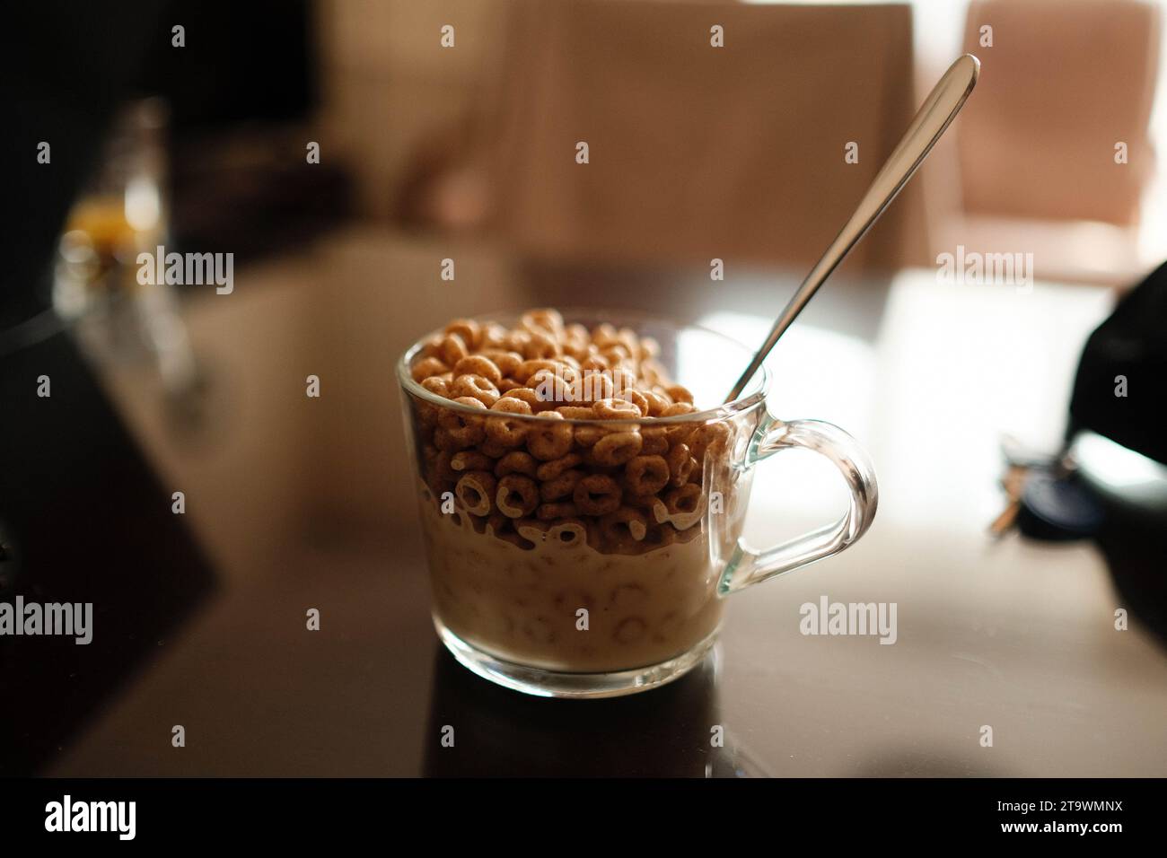Cheerios with milk in glass cup with spoon Stock Photo - Alamy