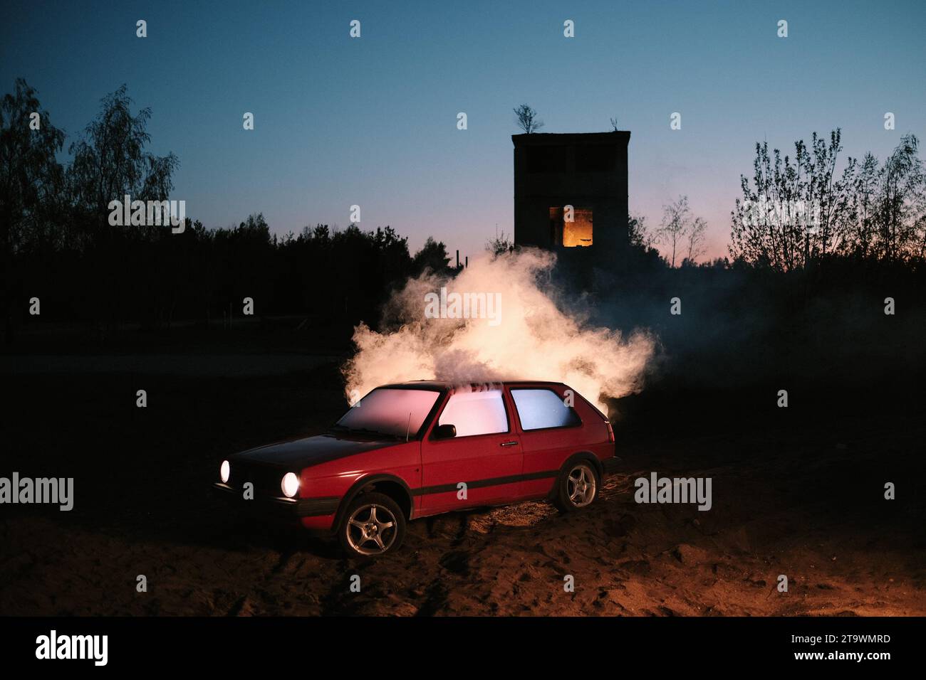Smoking car at sunset Stock Photo - Alamy